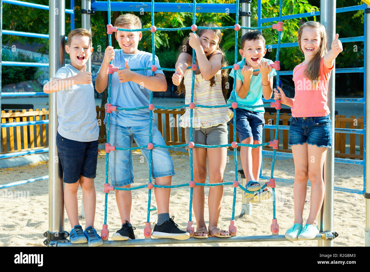 Five glad kids posing at the playground together Stock Photo - Alamy
