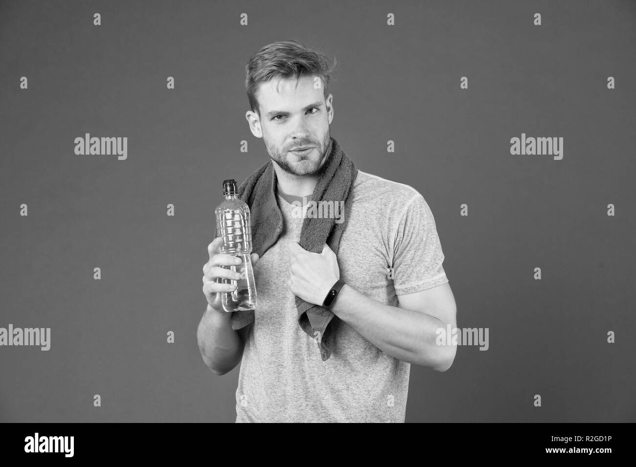 Stay hydrated. Drink some water. Man athlete with towel on shoulders ...
