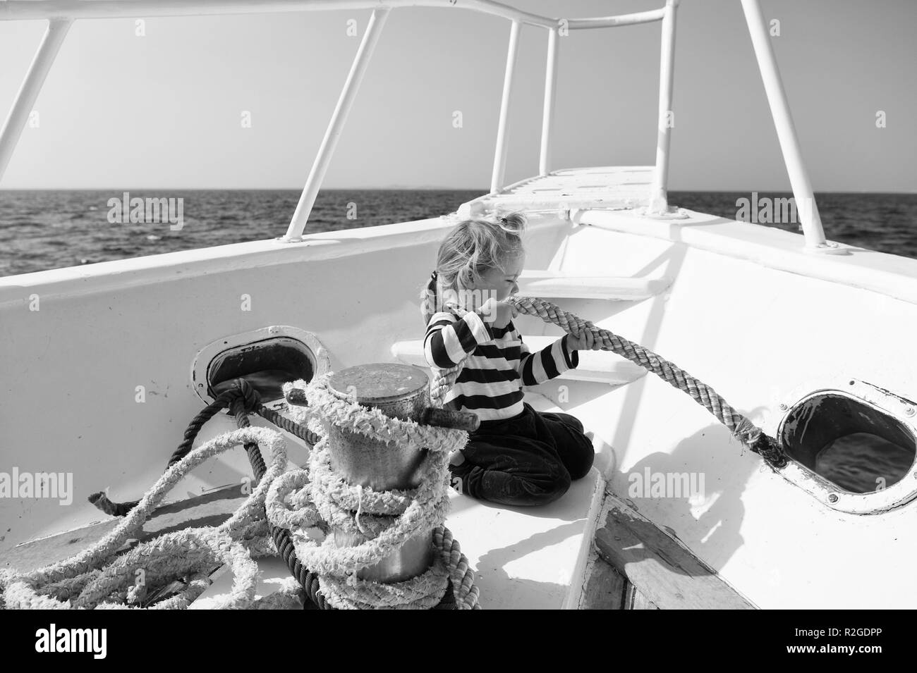 Little helper. Boy adorable sailor striped shirt yacht travel around ...