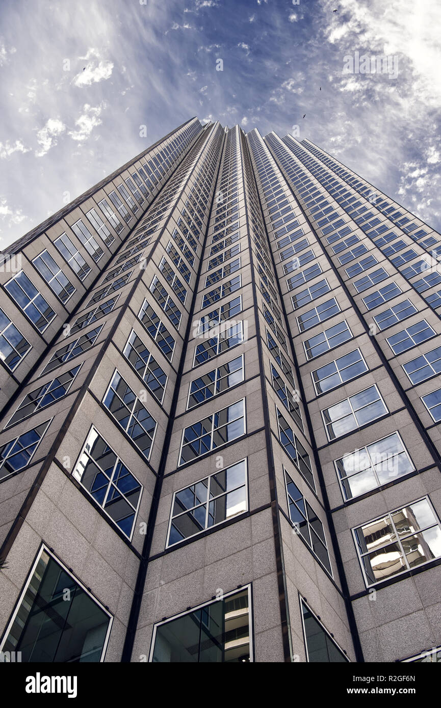 perspective wide angle view to steel blue background of glass high rise ...