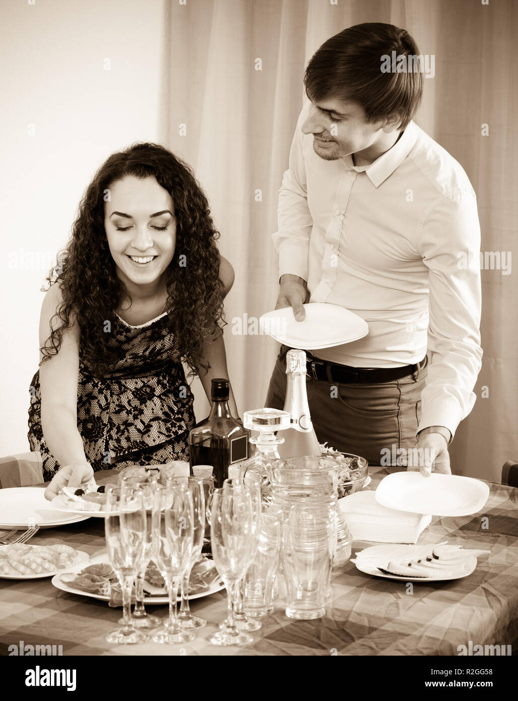 House party. Happy man and beautiful woman getting ready for the ...