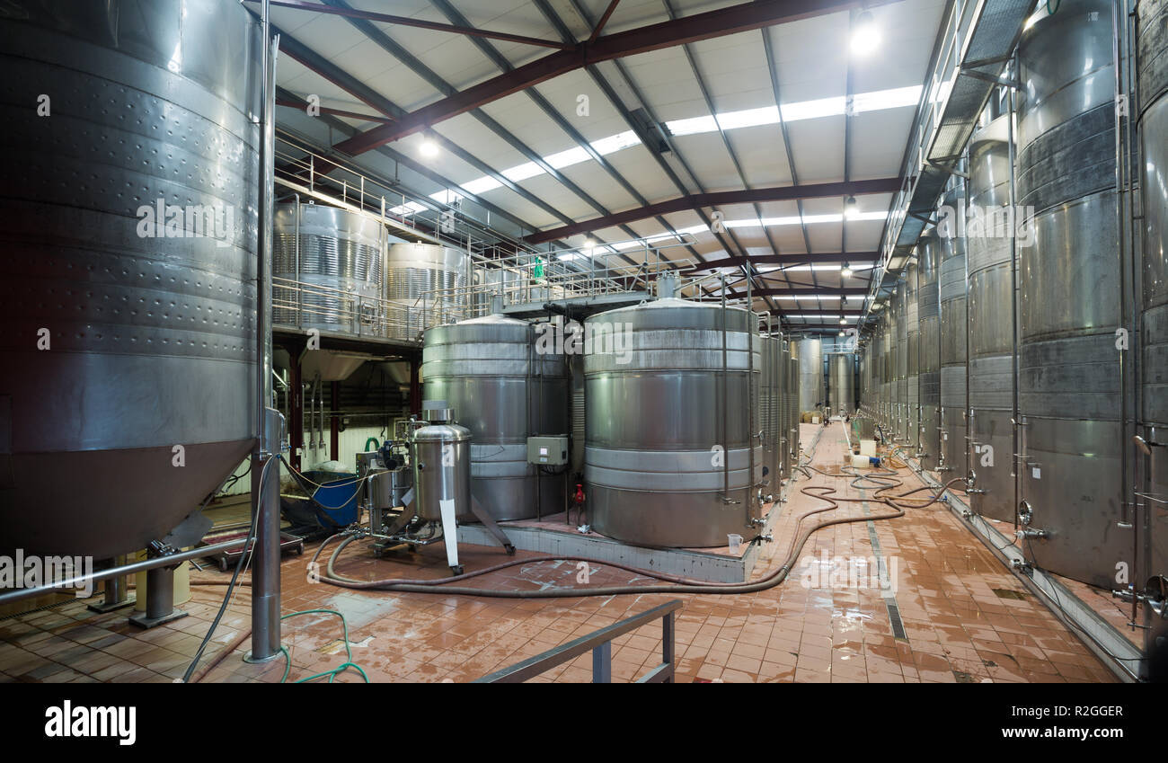 Interior of winery factory with stell barrels Stock Photo - Alamy