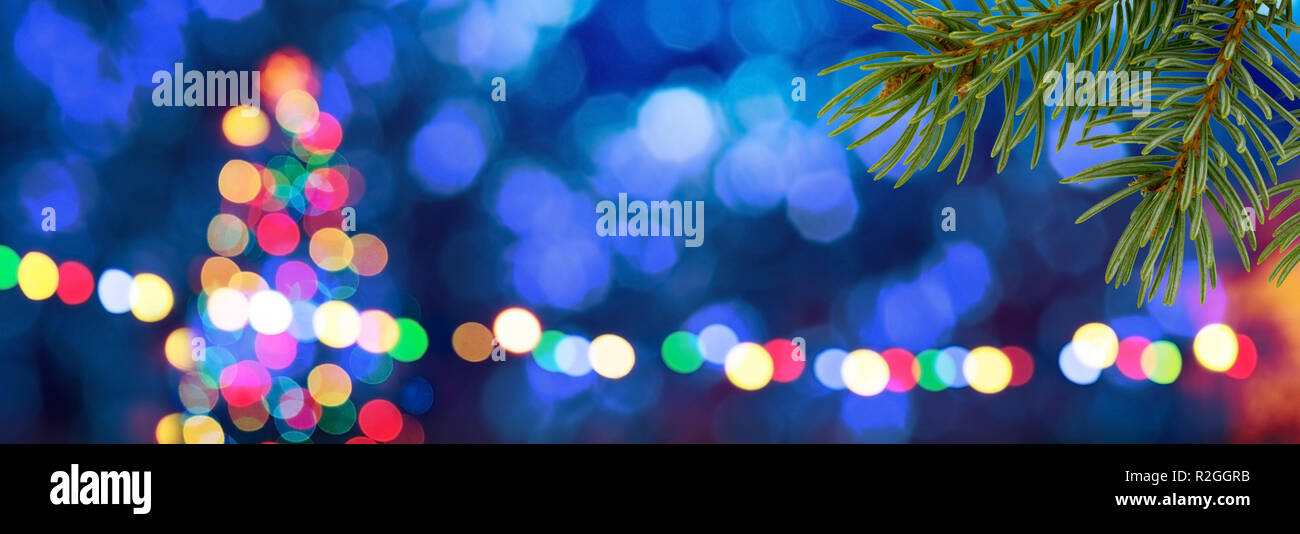 Blue unfocused background with colored christmas tree Stock Photo - Alamy