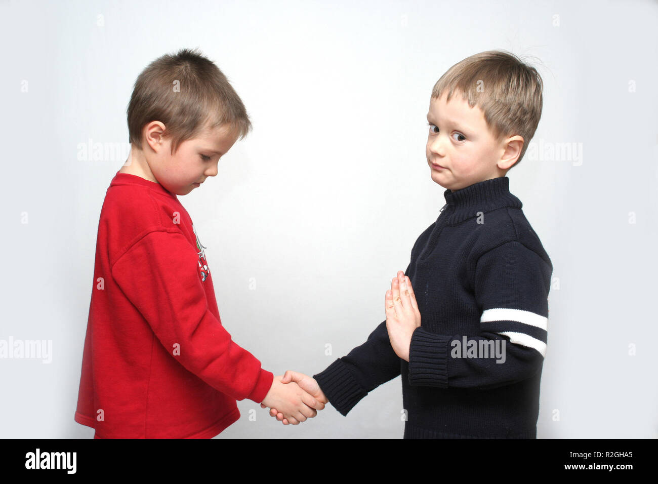 Two kids friends handshake hi-res stock photography and images - Alamy