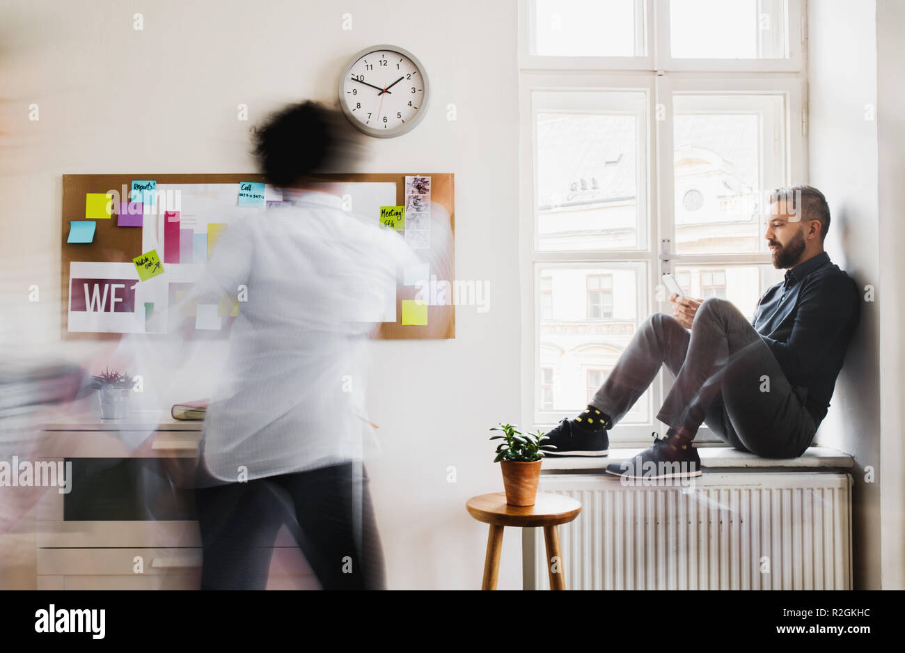 Young businesspeople in a modern office, having break. Motion blur ...