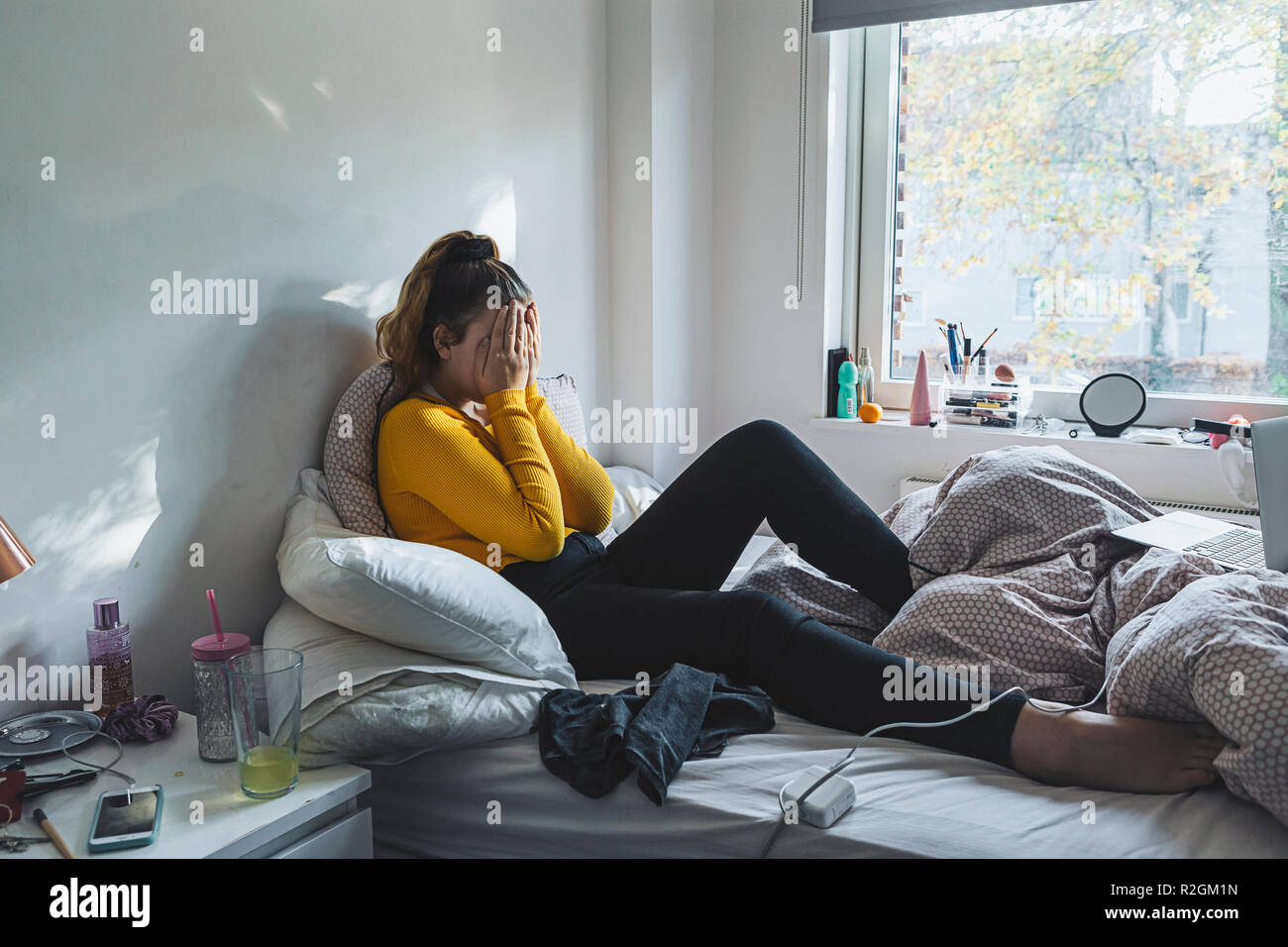 Sad teenage girl in bedroom Stock Photo - Alamy