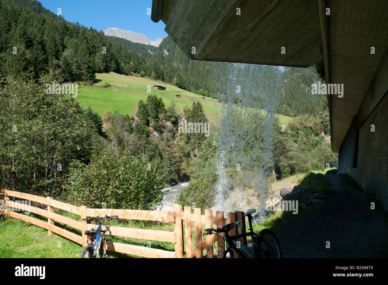 Tyrolean Alpine landscape as seen through a curtain of water from ...