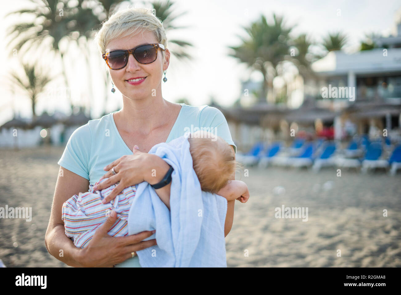 Mother holding son in her arms hi-res stock photography and images - Alamy