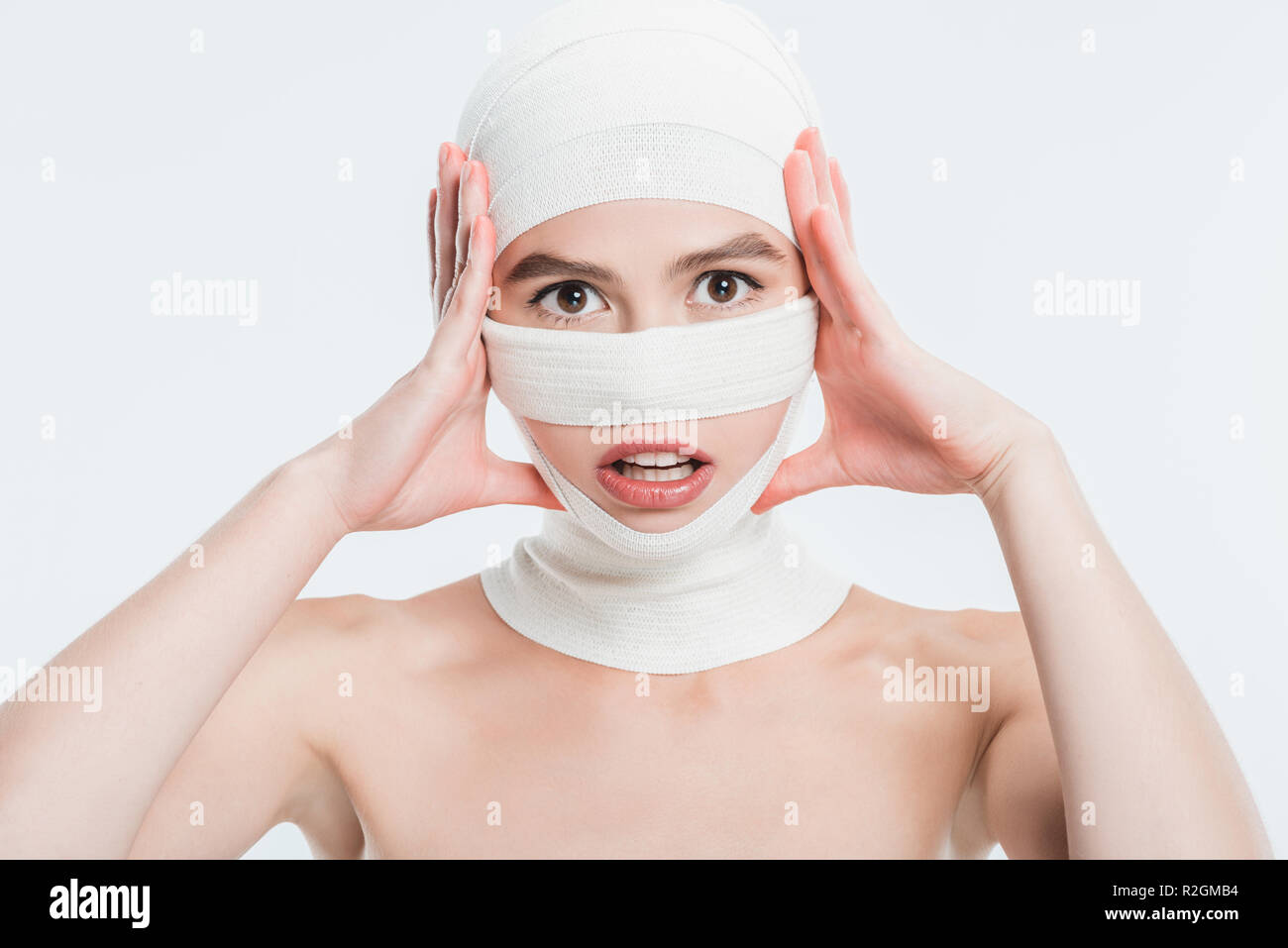close up of woman with bandages over head after plastic surgery ...