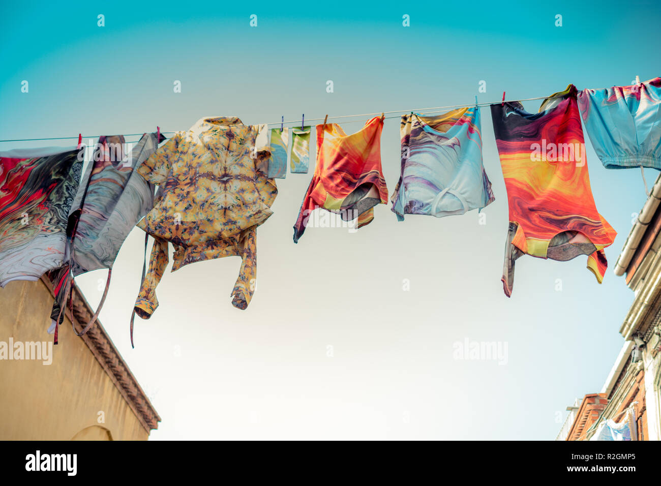 Clothes hanging from a clothes line rope in the street Stock Photo - Alamy