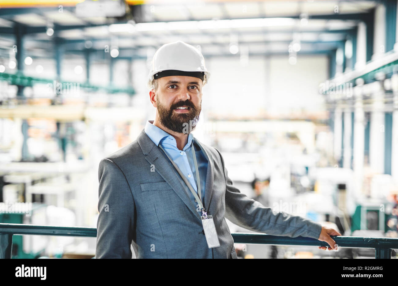 A portrait of an industrial man engineer standing in a factory Stock ...