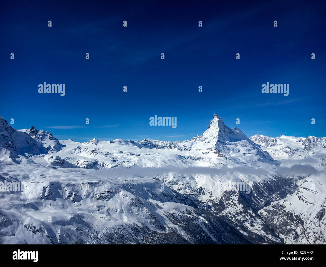 Majestic Matterhorn mountain in front of a blue sky with clouds seen ...