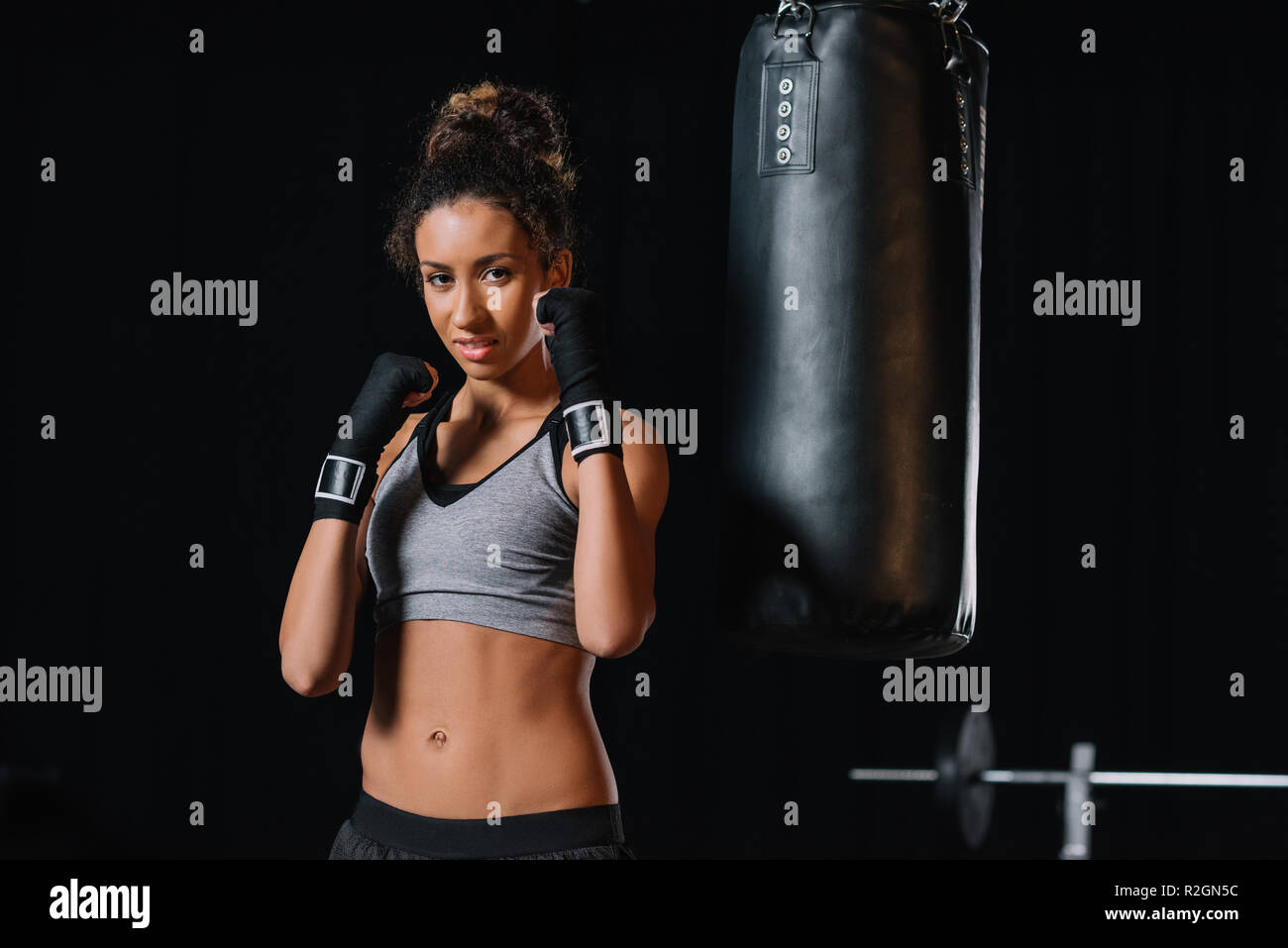 young african american female boxer posing in fight position near ...
