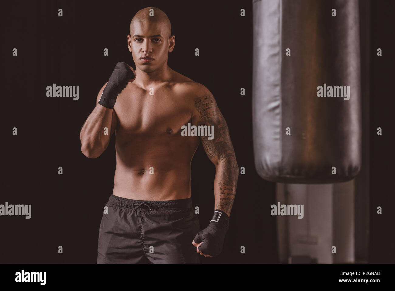 confident african american boxer posing near punching bag at gym Stock ...