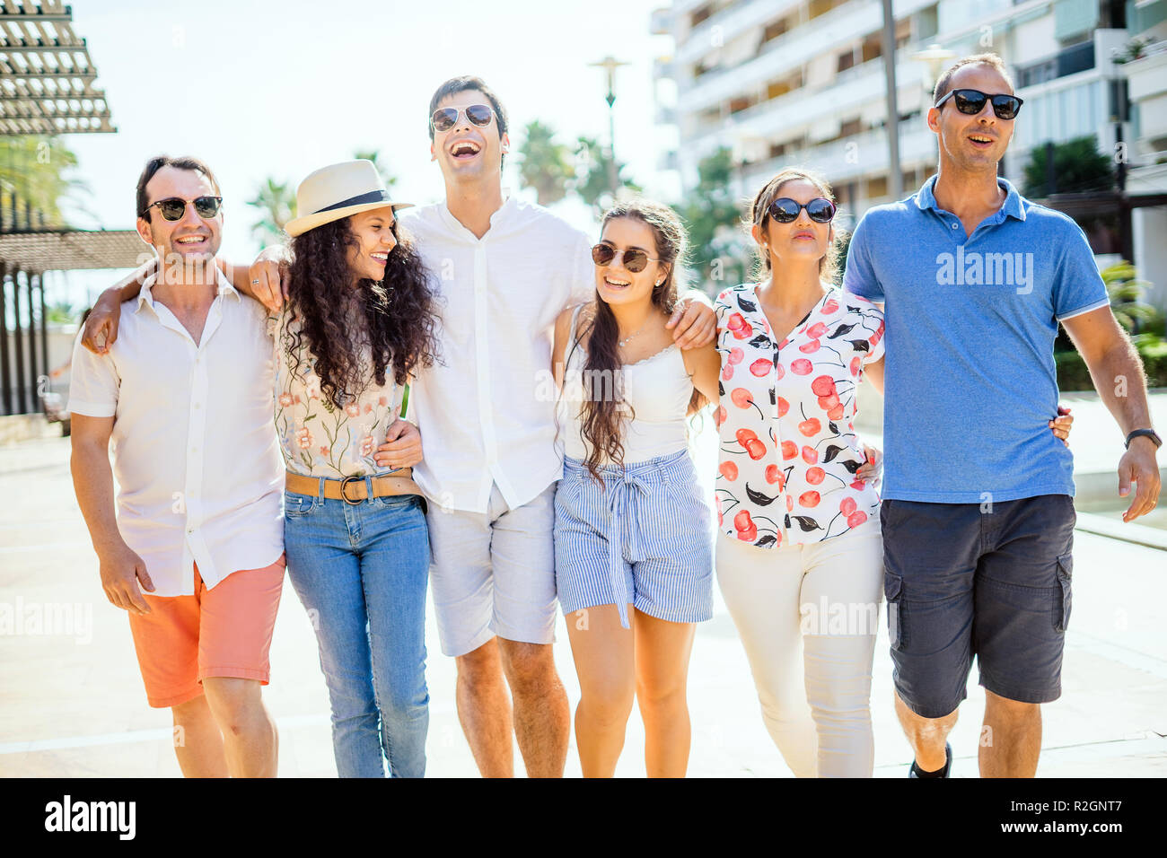 Six friends walking, taking, laughing and having fun during day time in ...