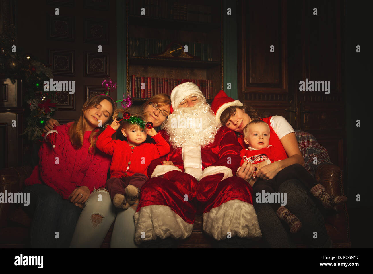 Christmas family portrait in a festive living room with a real Santa ...