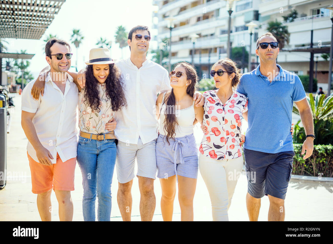 Six friends walking, taking, laughing and having fun during day time in ...