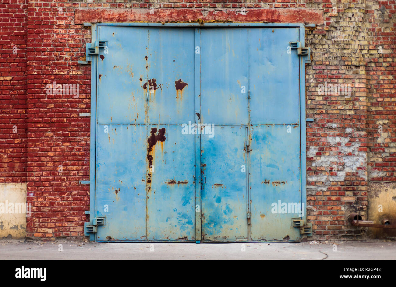 Old warehouse rusty entry with aged red brick wall texture may be used ...