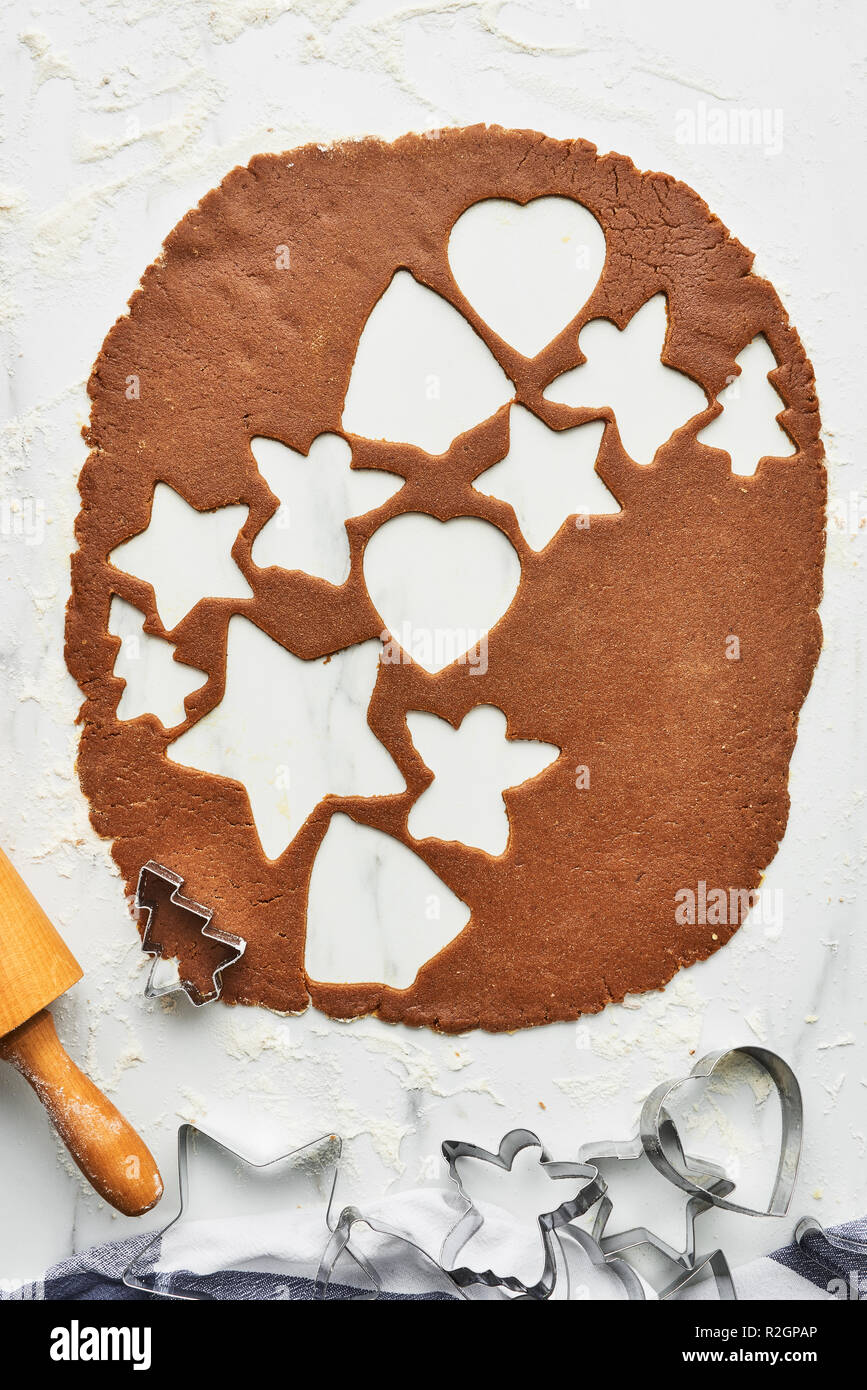 Gingerbread dough with various shape cookie cutout. Baking background ...