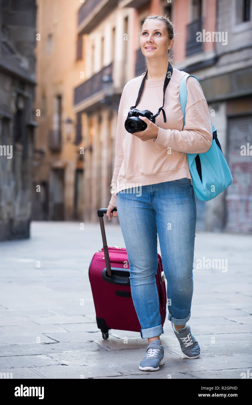 cheerful and inquisitive young woman taking a journey in the city Stock Photo - Alamy
