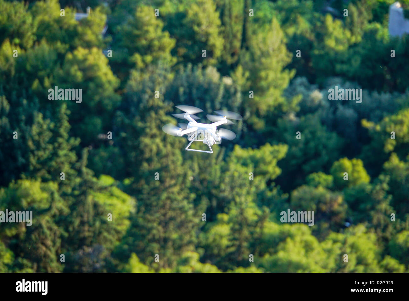 Drone flying on a lush green tree foliage background Stock Photo - Alamy