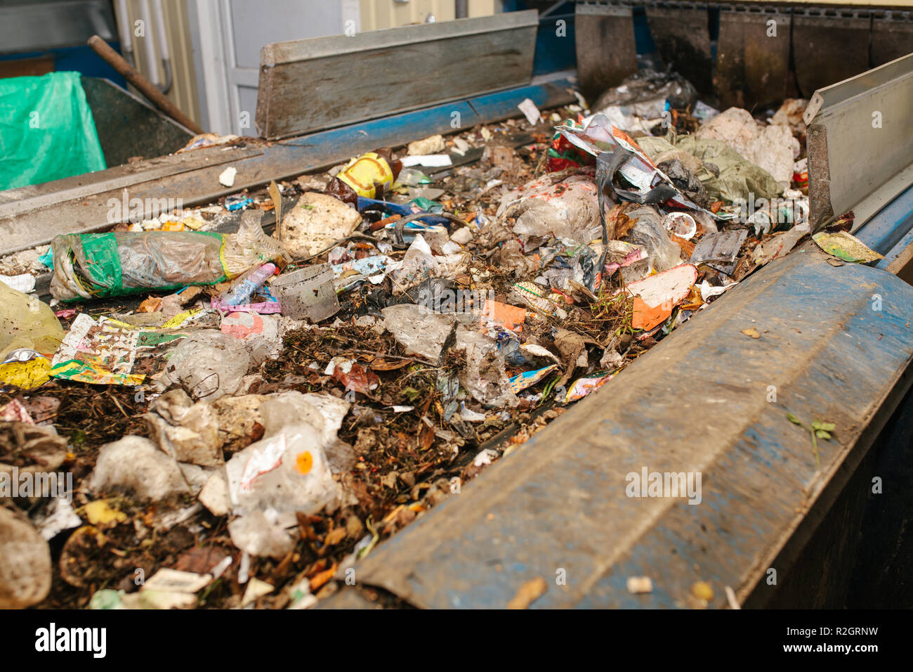 Waste sorting plant. Conveyor on which waste is moving to enter the ...