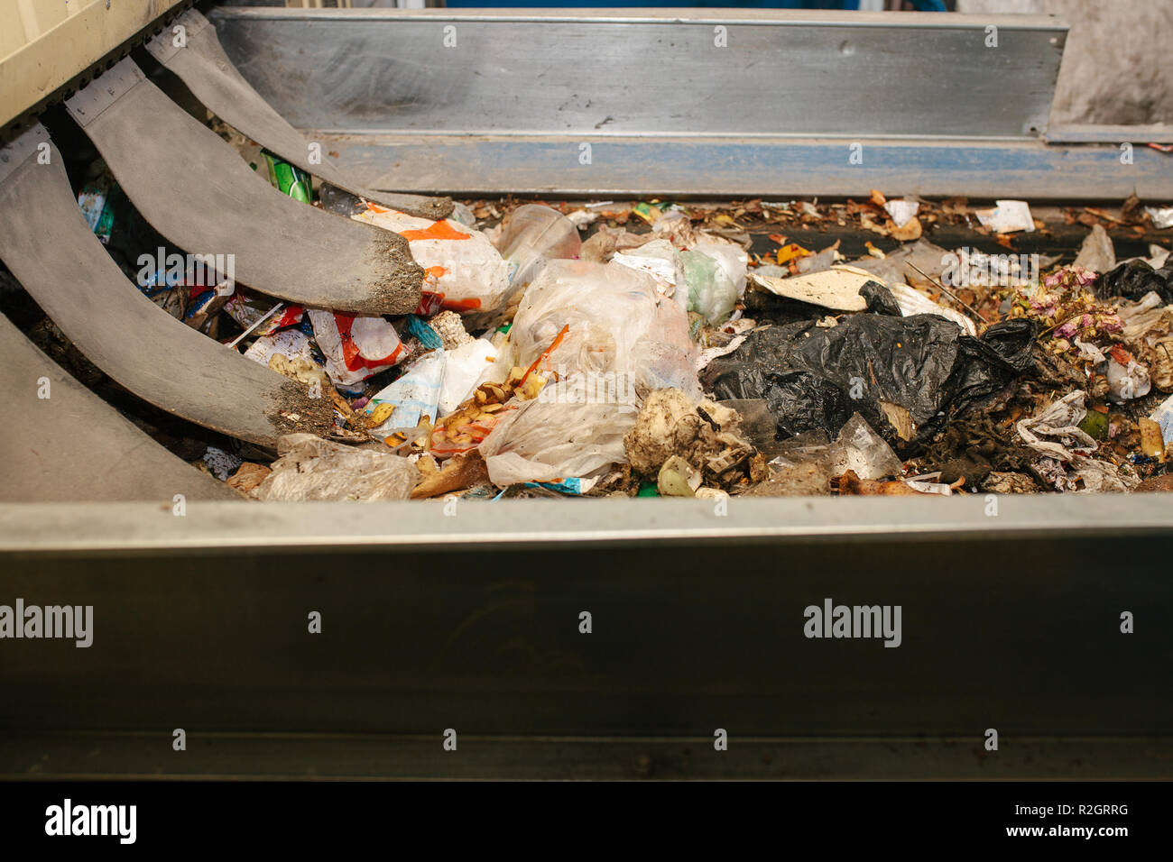 Waste sorting plant. Conveyor on which waste is moving to enter the ...