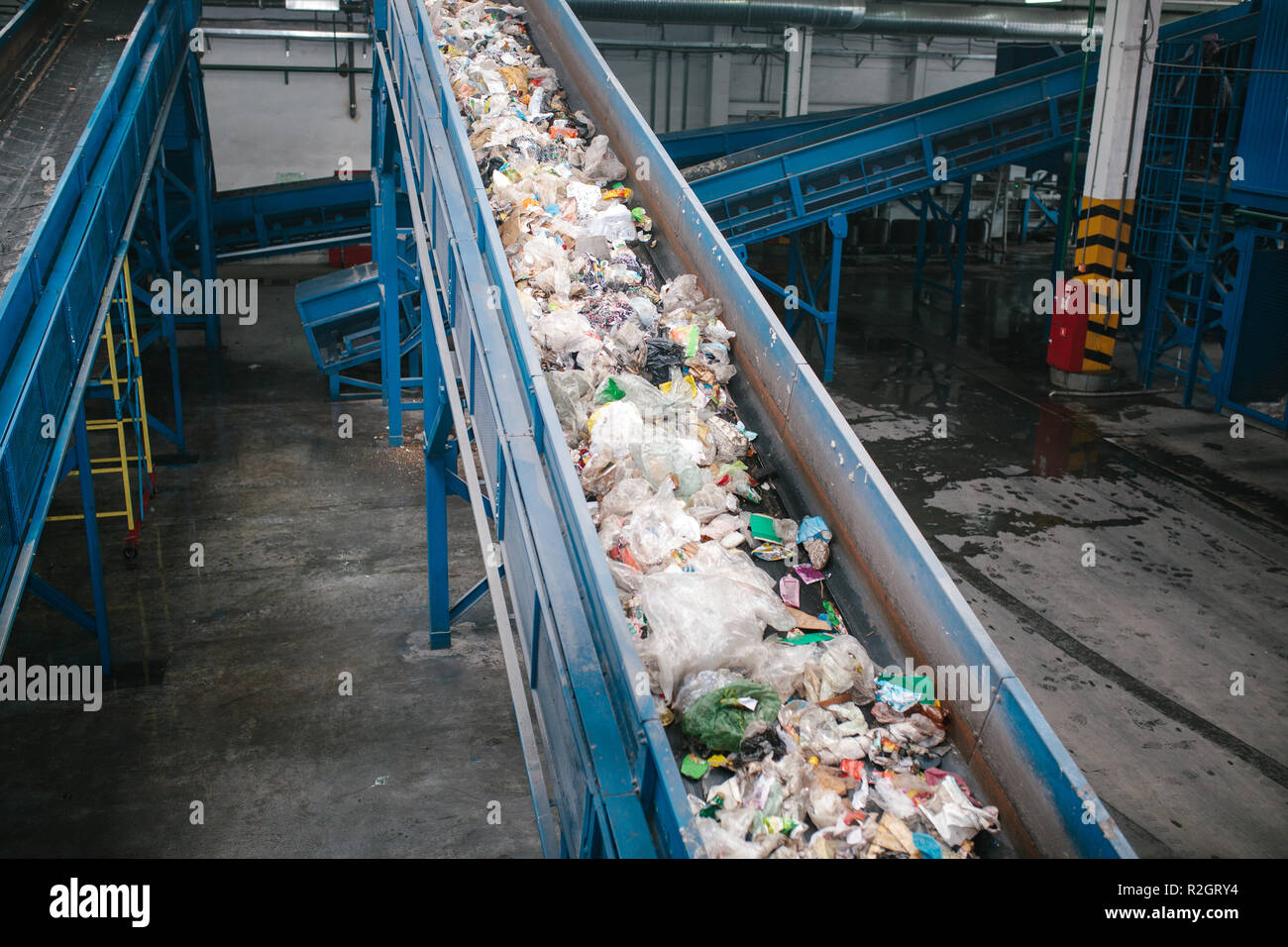 Waste sorting plant. Conveyor on which waste is moving to enter the ...