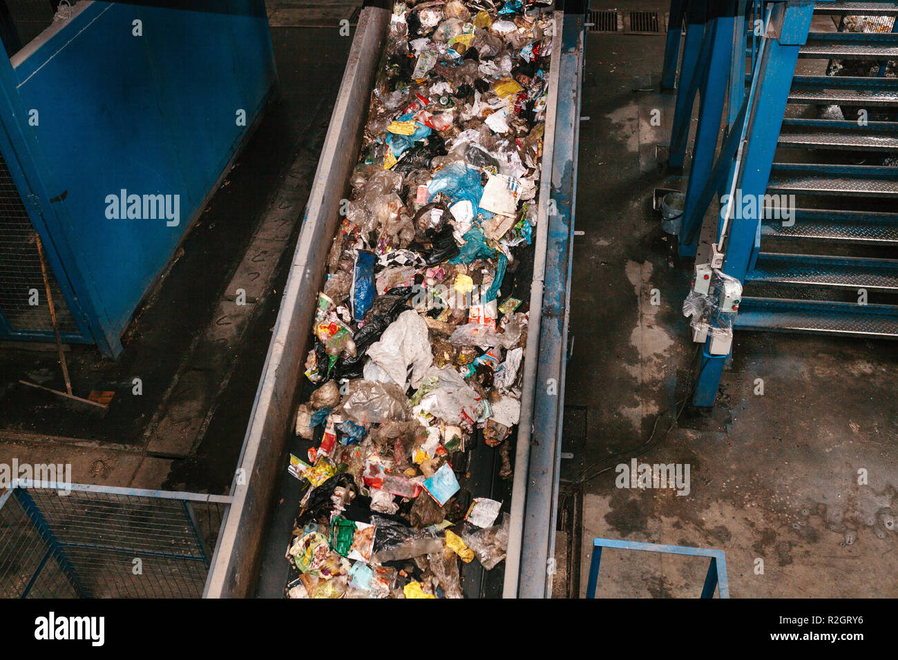 Waste sorting plant. Conveyor on which waste is moving to enter the ...
