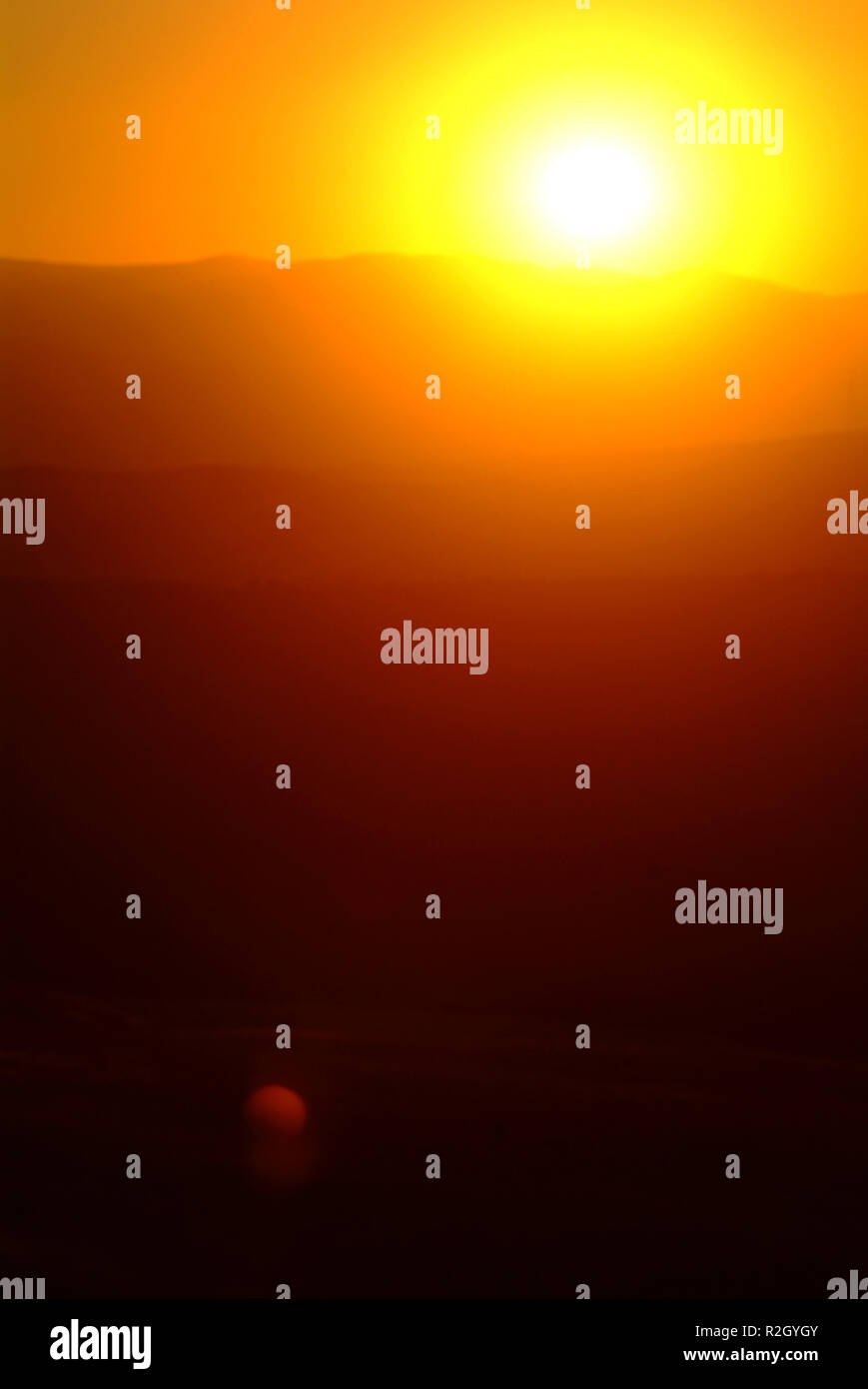 sunset behind hill Stock Photo - Alamy