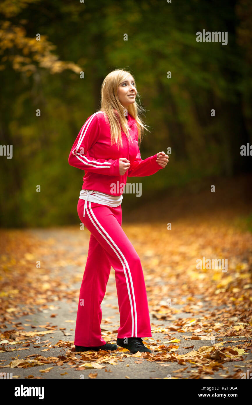 Woman running in autumn fall forest. Female runner training outdoor ...