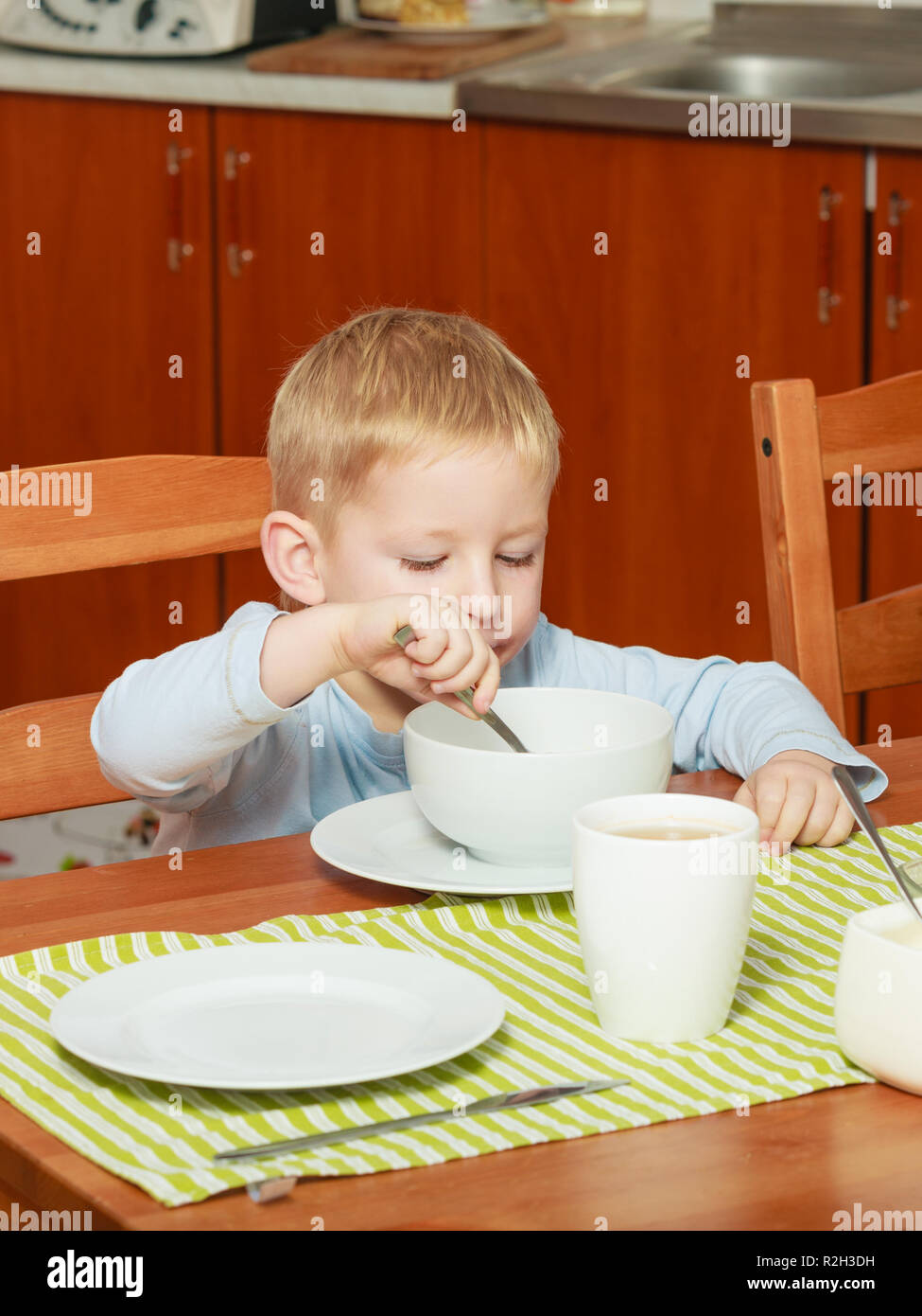 Morning routine in family, healthy diet for children concept. Kid boy ...