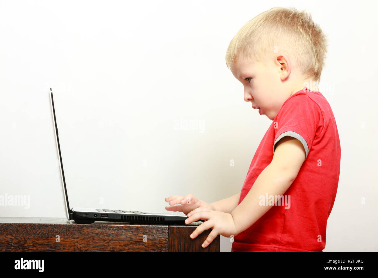 Children, technology and home concept - little boy kid child using ...