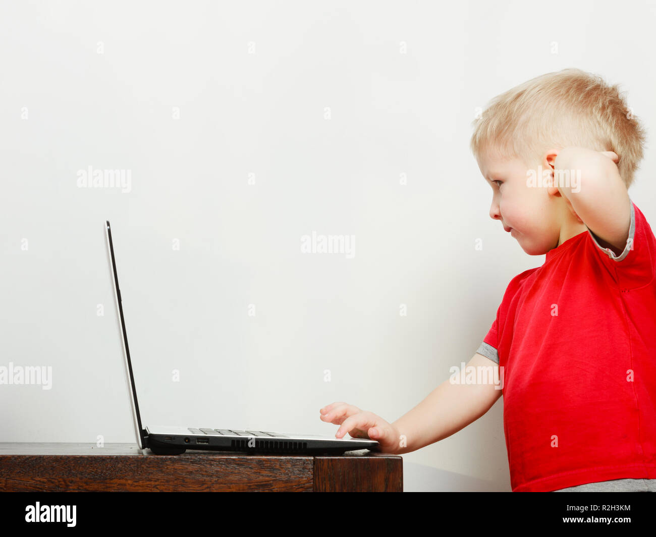 Children and technology, spending free time online concept. Little boy ...