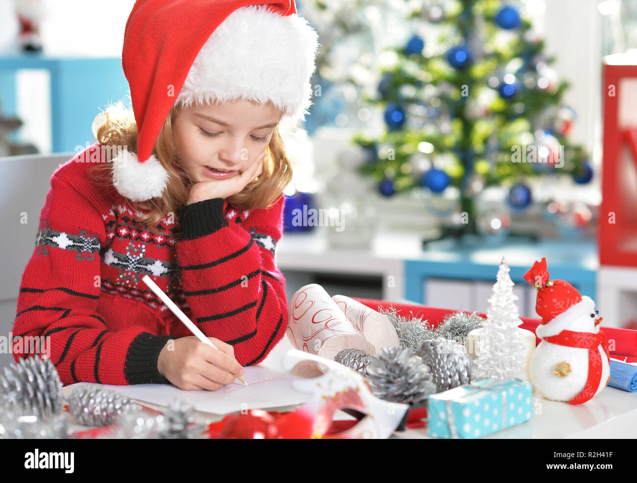 Portrait of cute little girl writing letter Stock Photo - Alamy