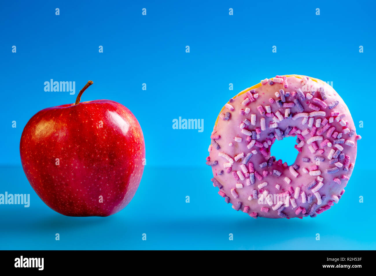 Apple and donut, concept of choice health and unhealthy diet Stock ...