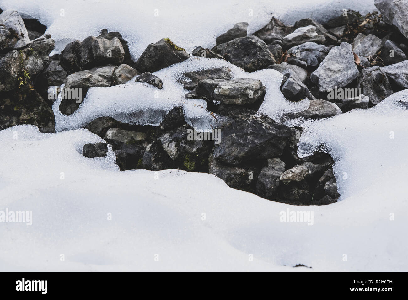 Stones covered by snow Stock Photo - Alamy