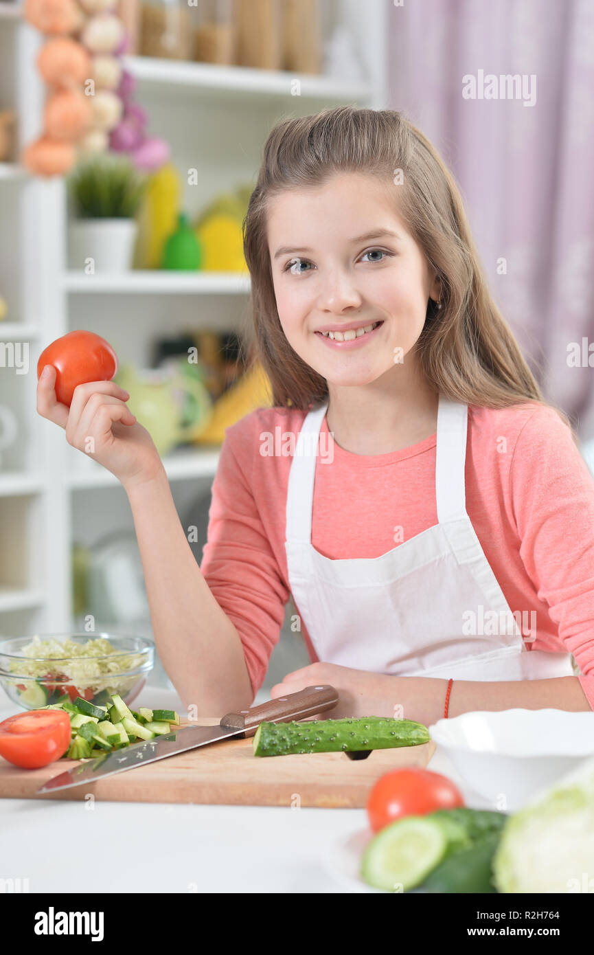 Portrait of beautiful young girl cooking in kitchen at home Stock Photo ...