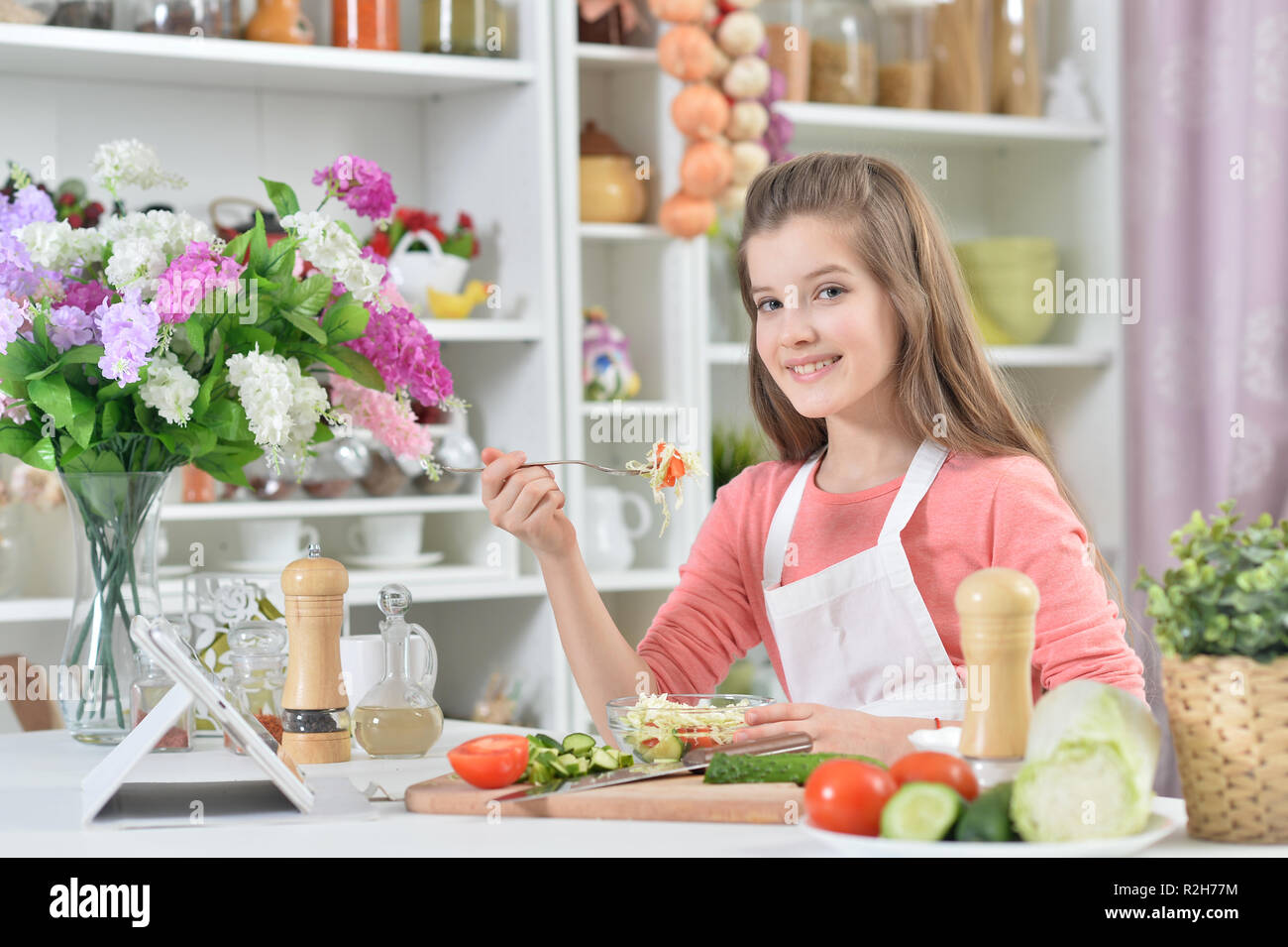 Portrait of beautiful young girl cooking in kitchen at home Stock Photo ...