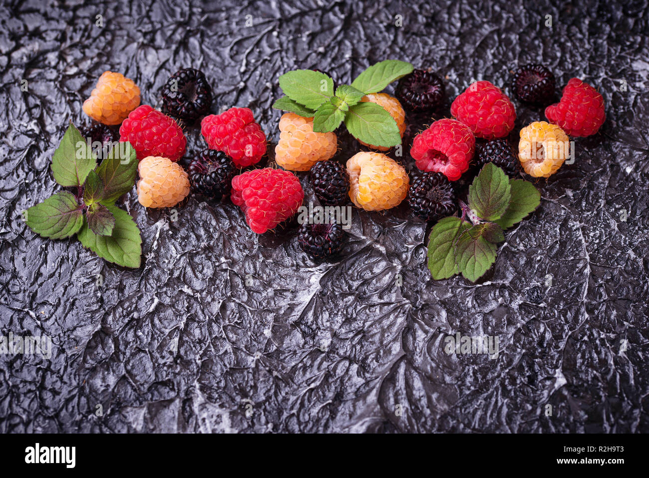Red, black and yellow raspberry Stock Photo - Alamy
