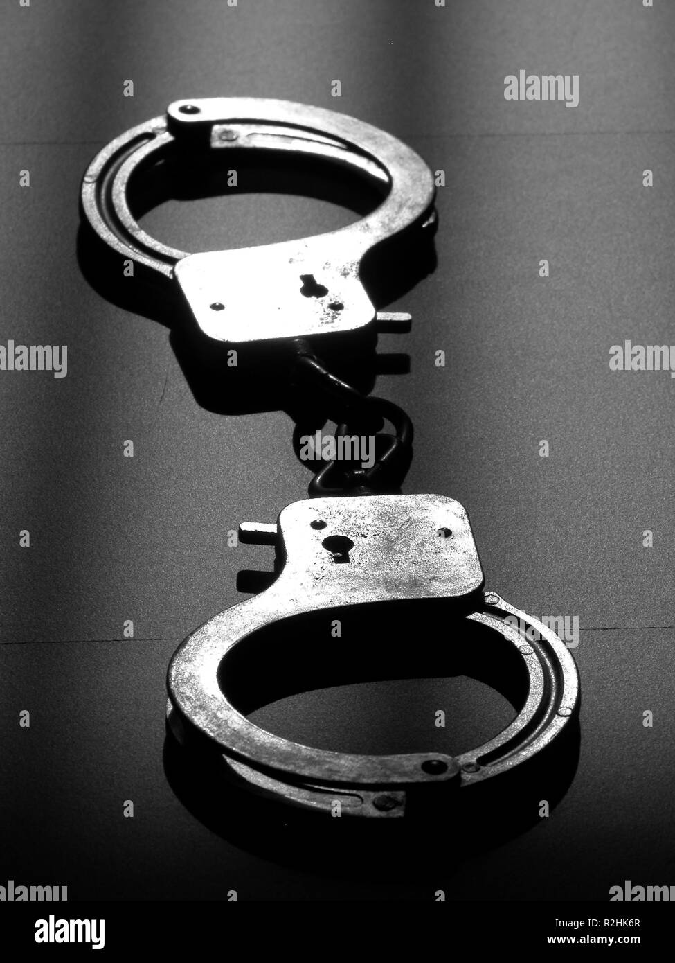 Jail cuffs Black and White Stock Photos & Images - Alamy