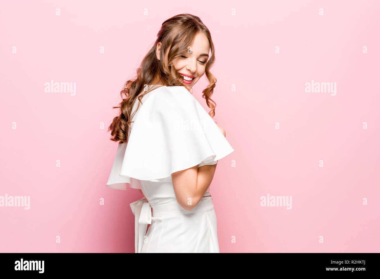 The young woman's portrait with happy emotions on pink background Stock ...