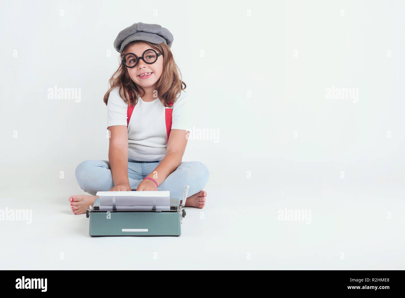 girl typing with a old typewriter on white background Stock Photo - Alamy