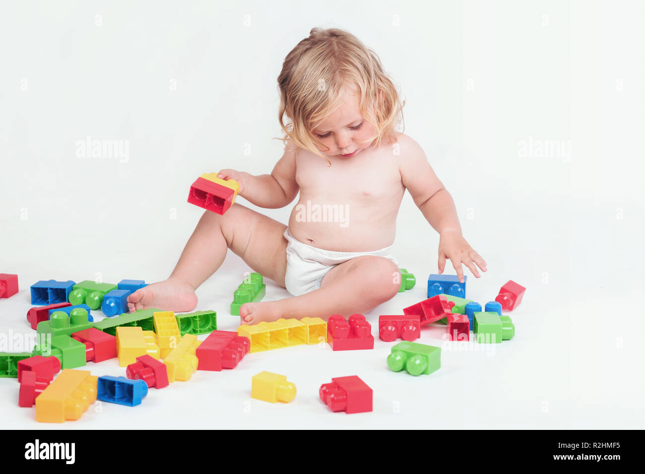 baby girl playing with building blocks on white background Stock Photo ...