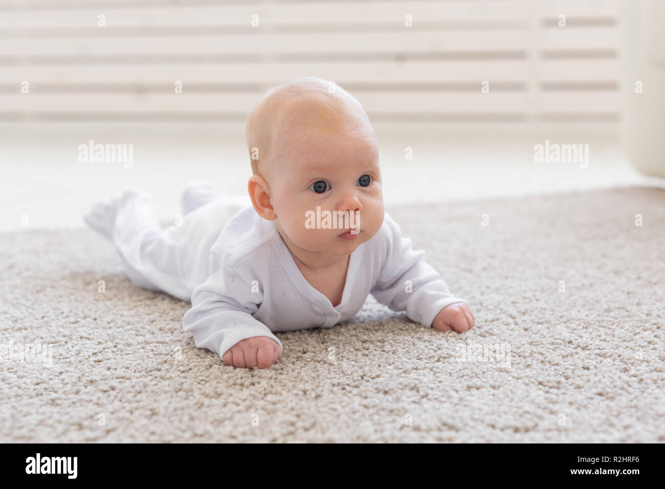 Child, childhood and infant concept - Pretty baby lie on the floor ...