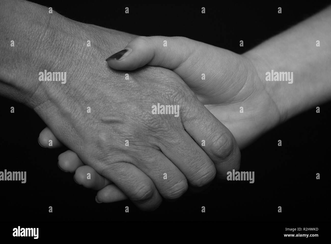 Old and young hand to hand Black and White Stock Photos & Images - Alamy