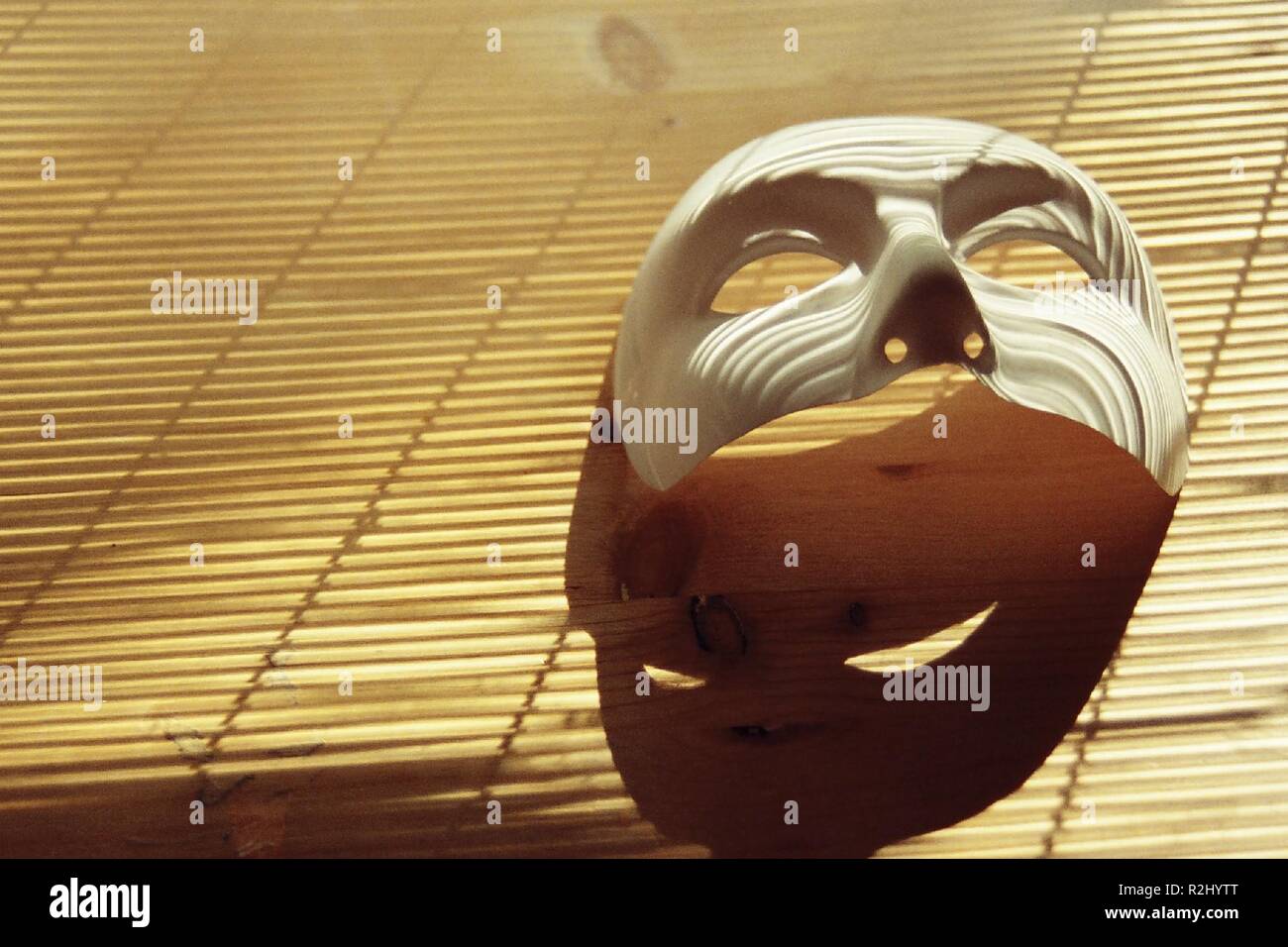 mask between light and shadow Stock Photo - Alamy