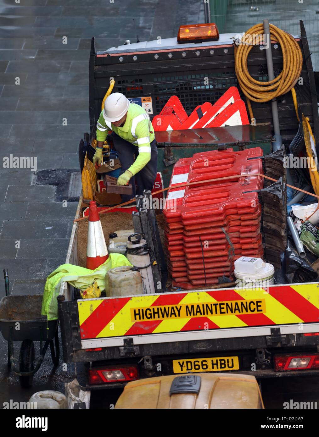 man climbing into builders truck Stock Photo - Alamy