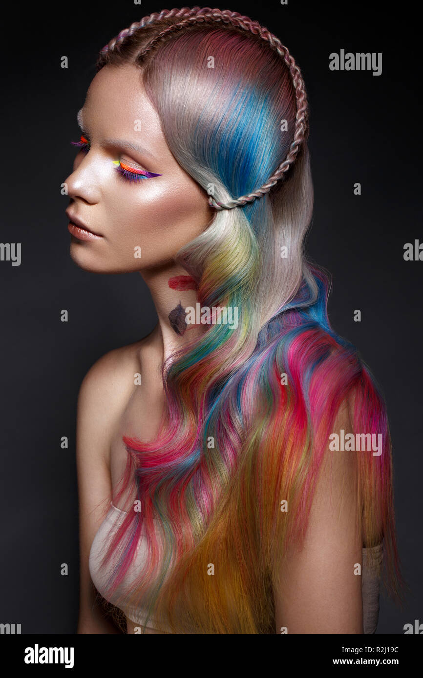 Beautiful girl with multi-colored hair and creative make-up and ...