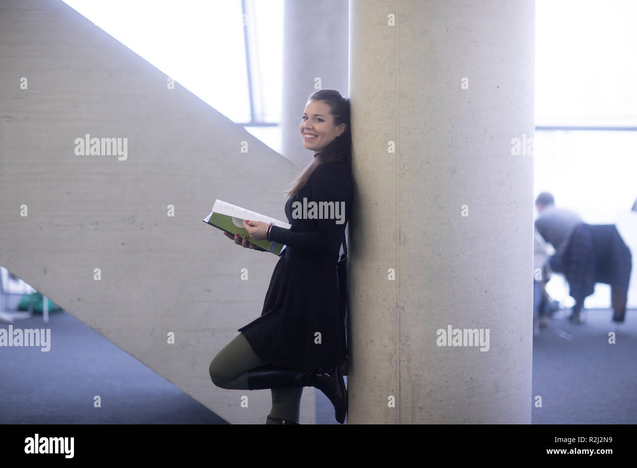 Woman standing by a column woman standing by a column hi-res stock ...